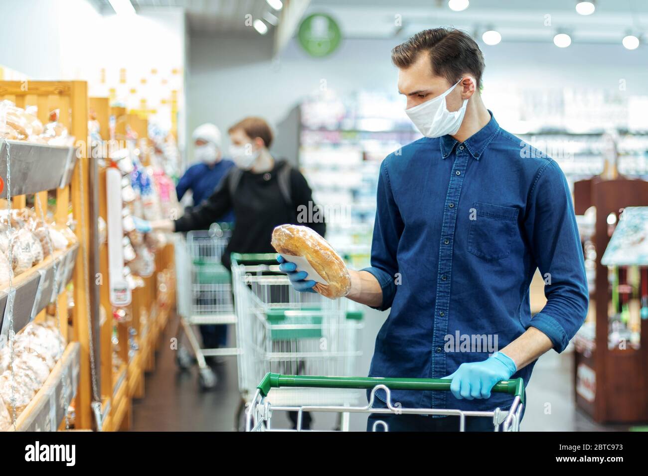 close up. young man buying bread in a supermarket Stock Photo - Alamy
