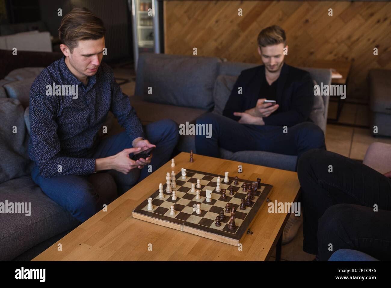 Men play chess in a stylish loft cafe with a modern design Stock Photo ...