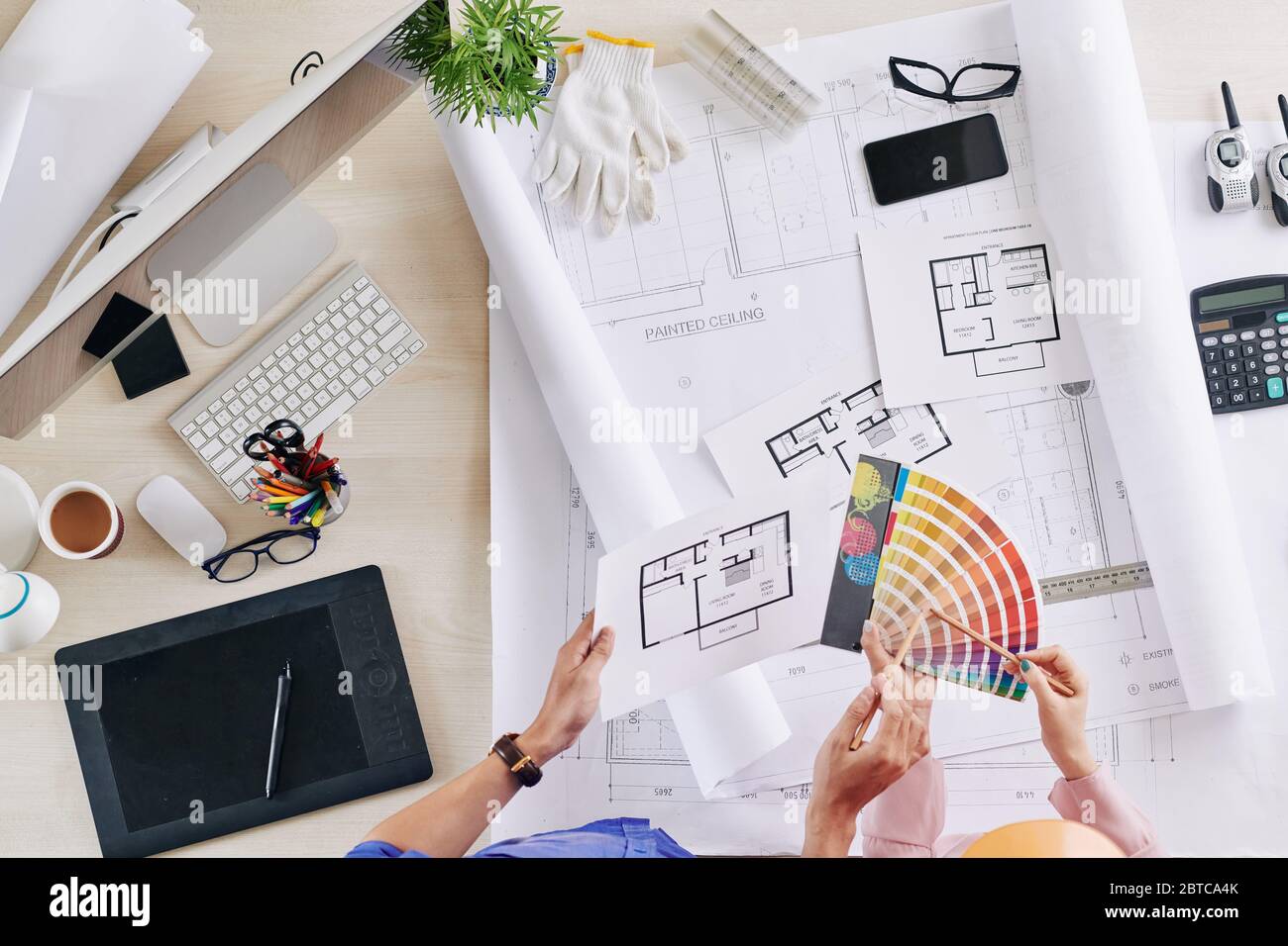 Color palette and apartment plans in hands of architect and engineer ...