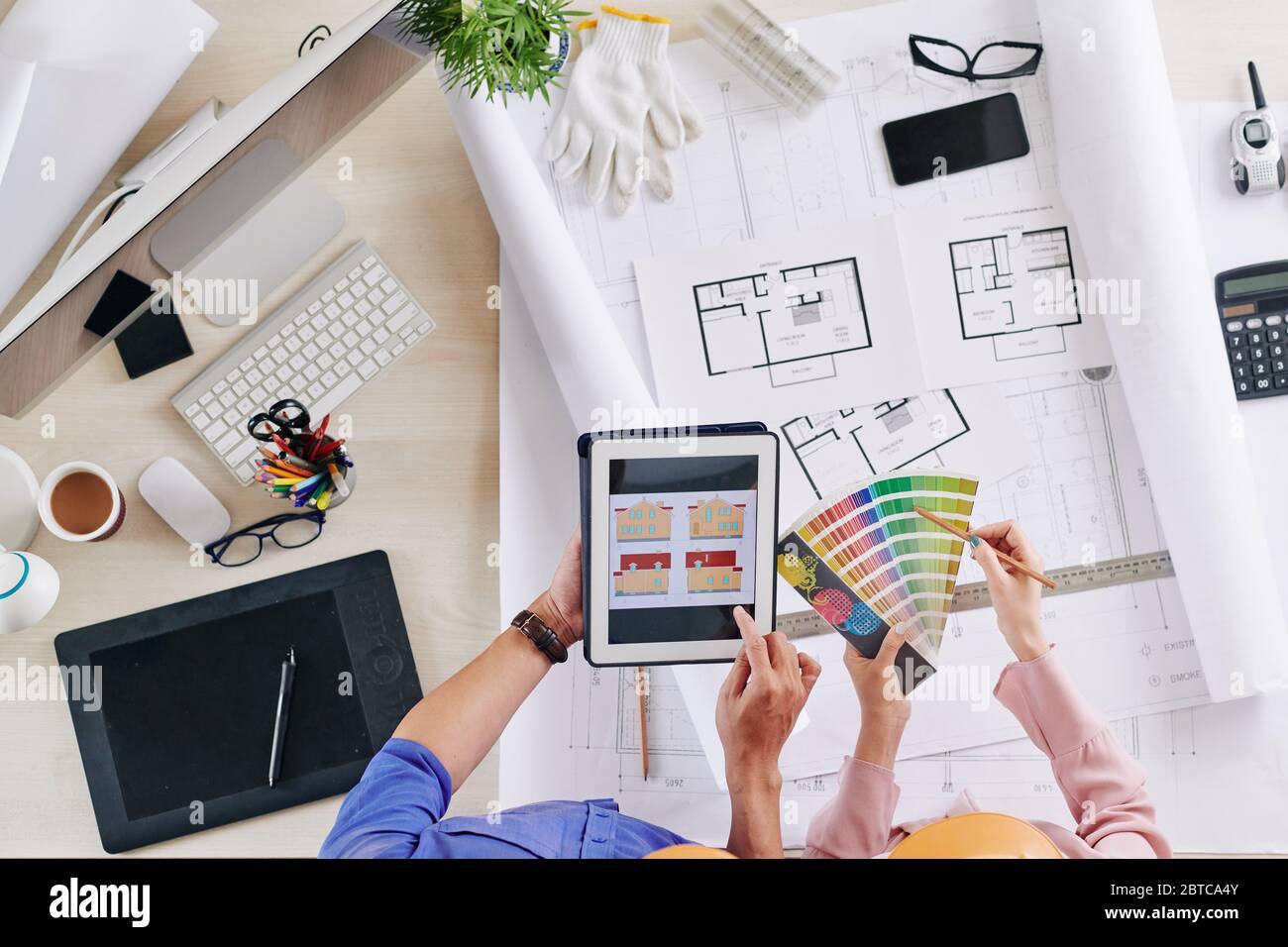 Architects choosing color of paint for exterior wall of new building ...