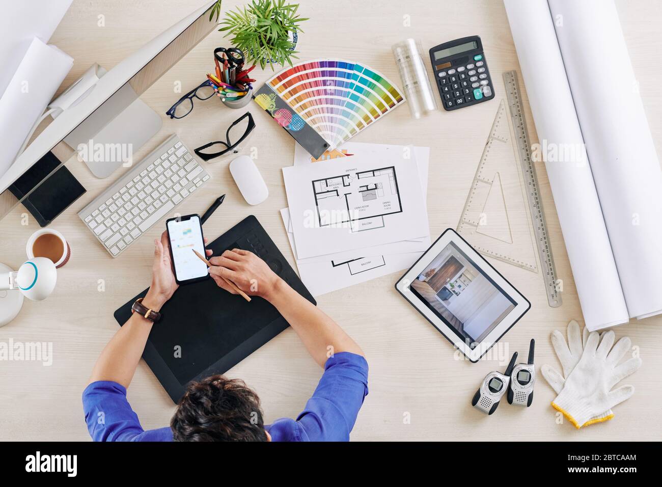 Freelance interior designer checking messages from clients in his ...