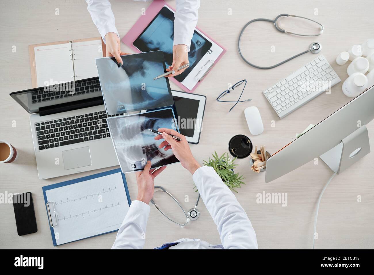 Pulmonologists comparing chest x-rays of sick and recovered patients ...