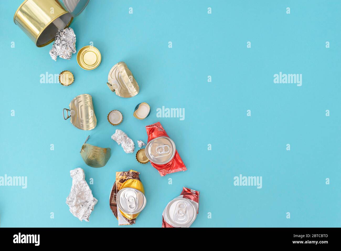 Metal garbage flies out of a metal can on the blue background. Waste ...