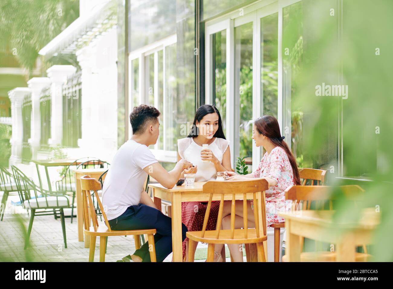 Group of friends having healthy breakfast in outdoor cafe Stock Photo ...