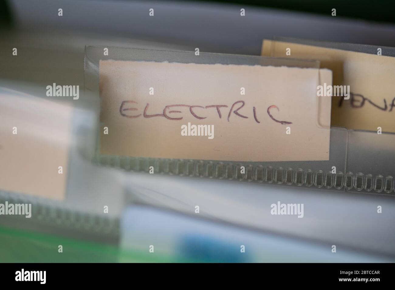 A label within a file organiser with the wording Electricity.Normally a ...