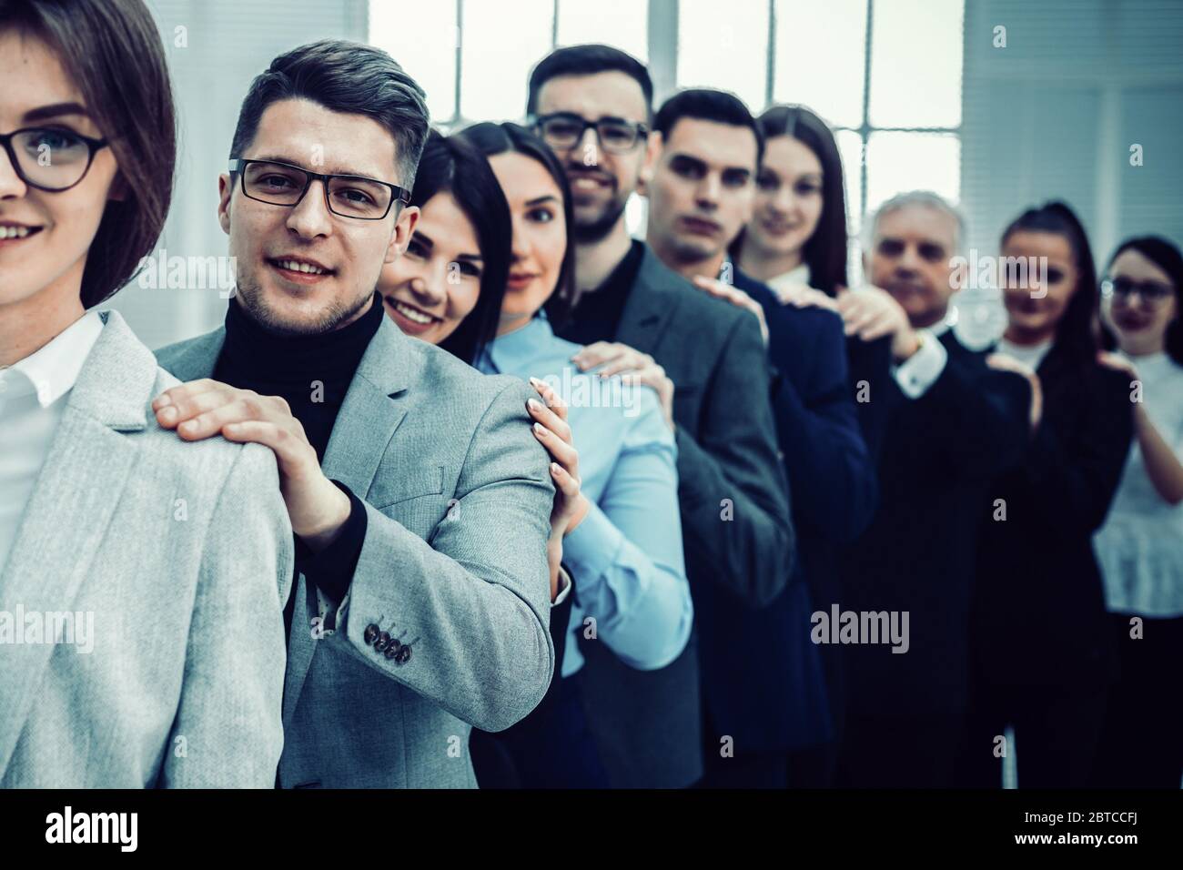 group of young business people standing behind each other Stock Photo ...