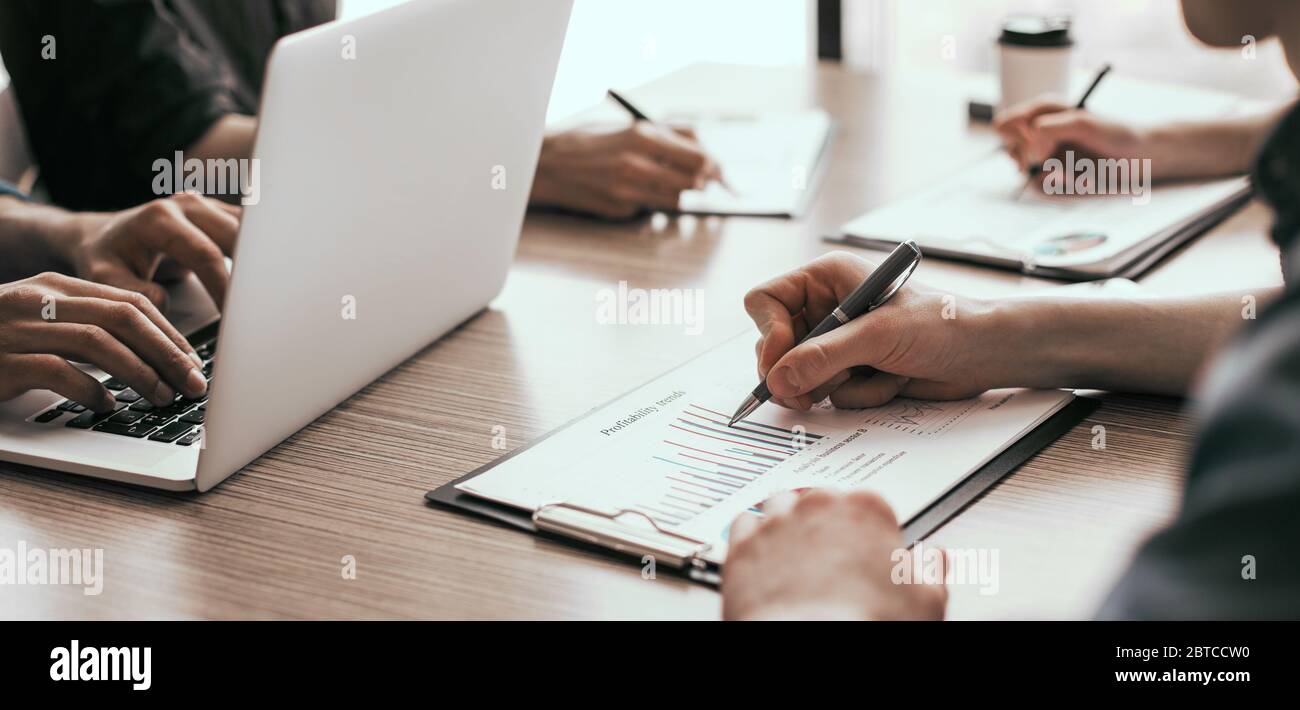 group of the employees analyzing financial charts Stock Photo - Alamy
