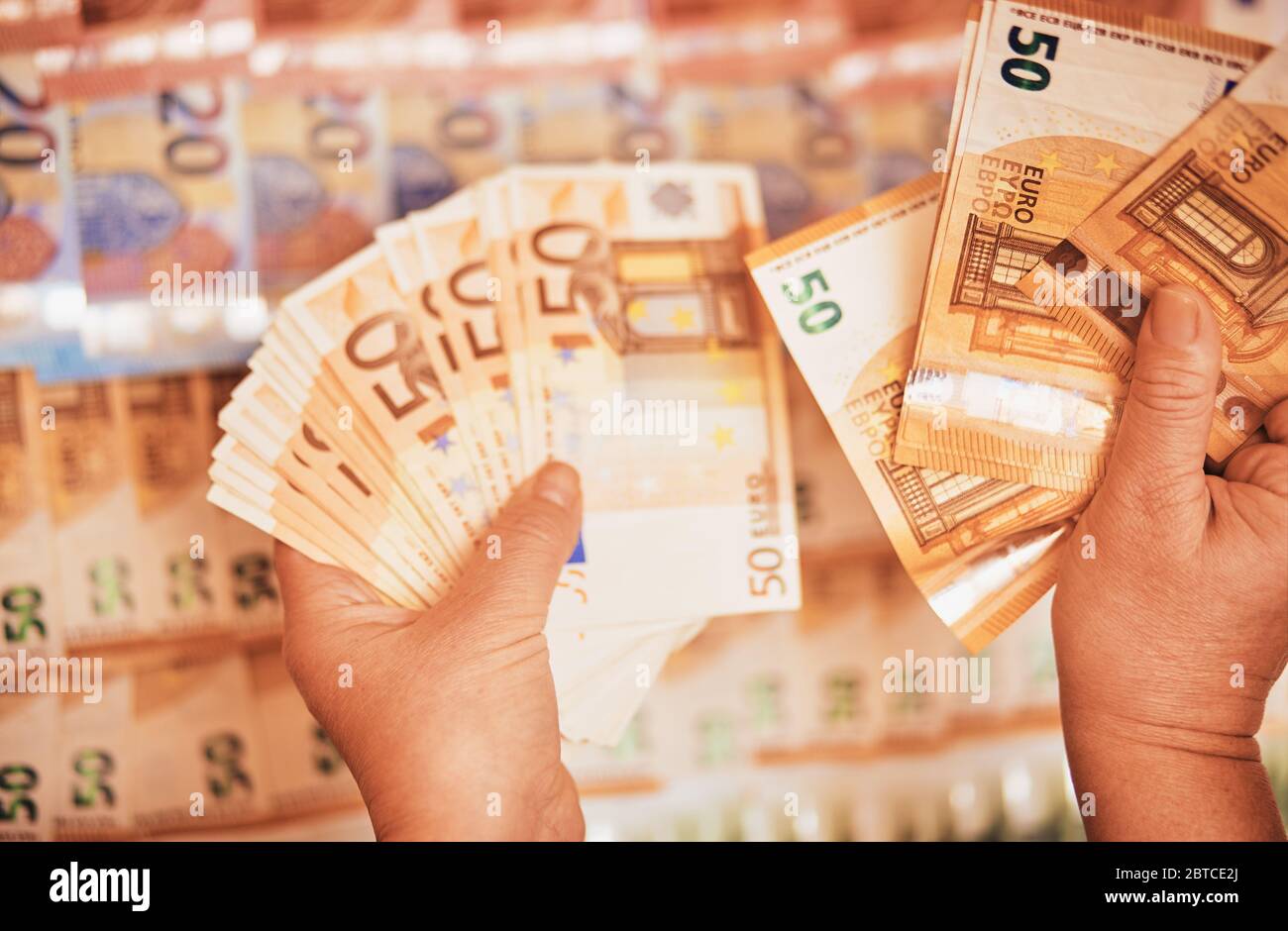 Woman giving euros hi-res stock photography and images - Alamy