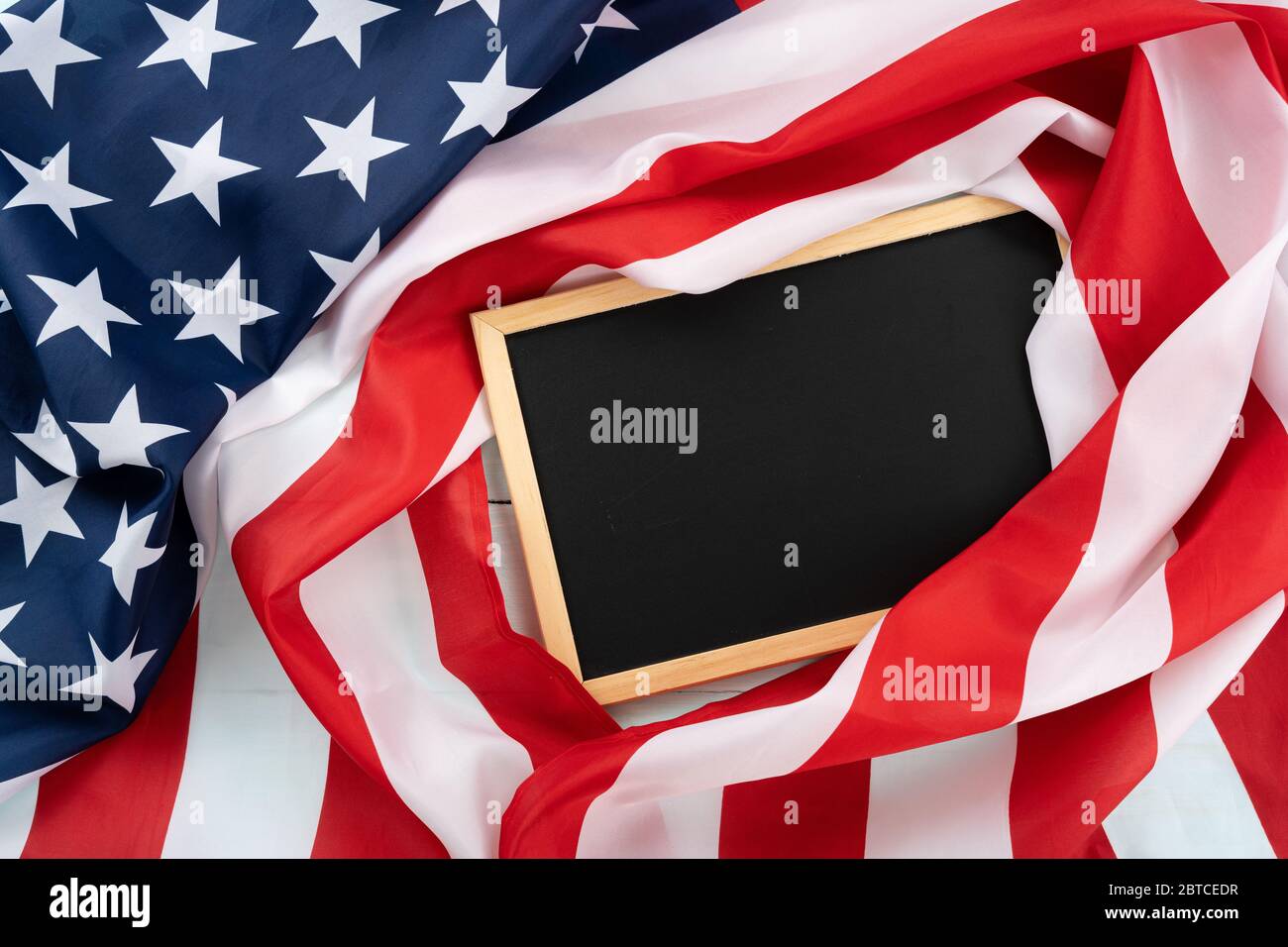 US American flag with blackboard on blue wooden background. For USA ...