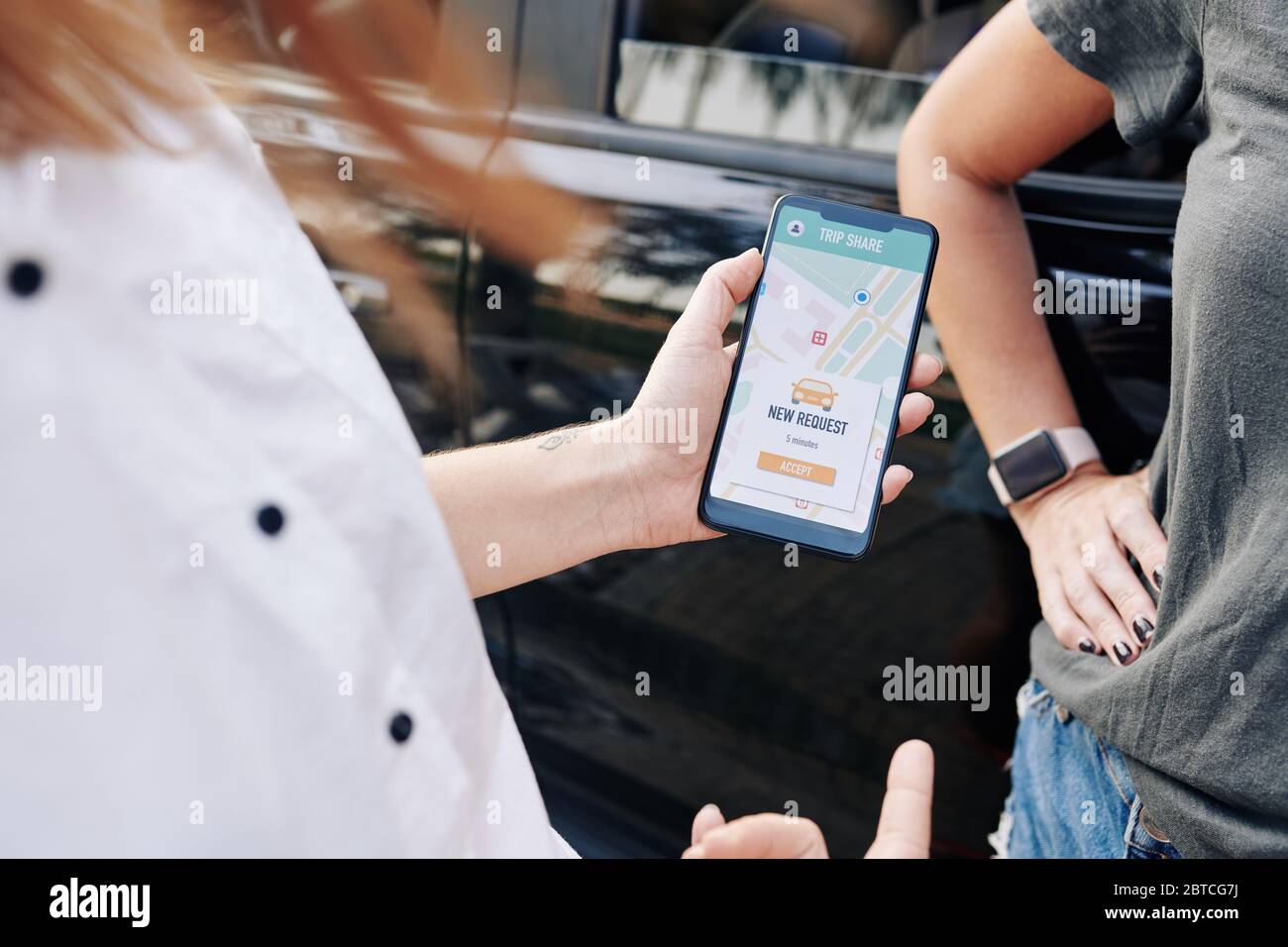 Female driver accepting request in car sharing application on her ...