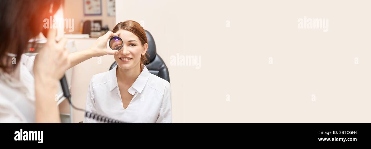 ophthalmologist doctor in exam optician laboratory with female patient ...