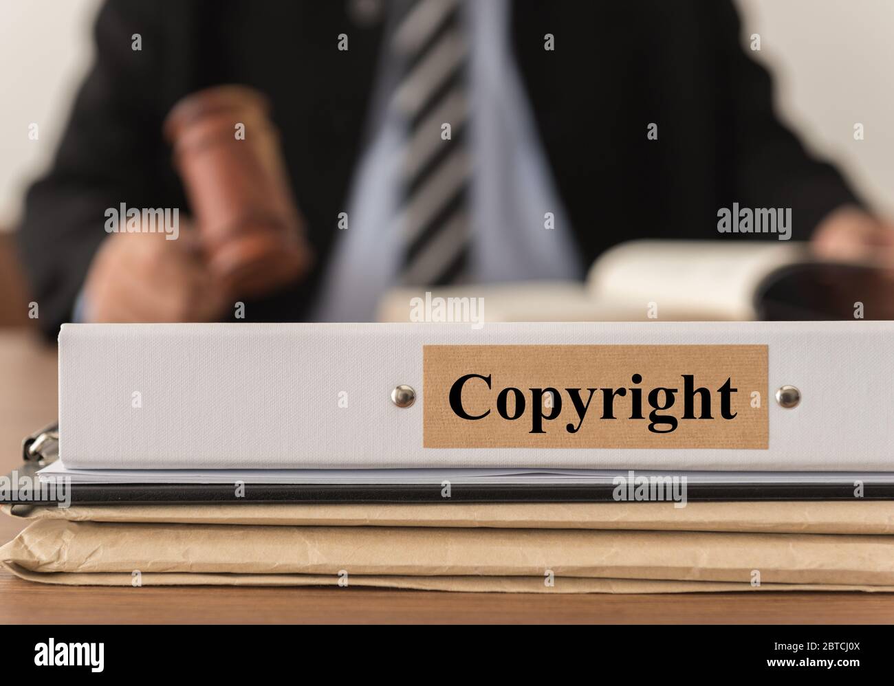 closeup copyright document folder with lawyer work at law firm. concept ...