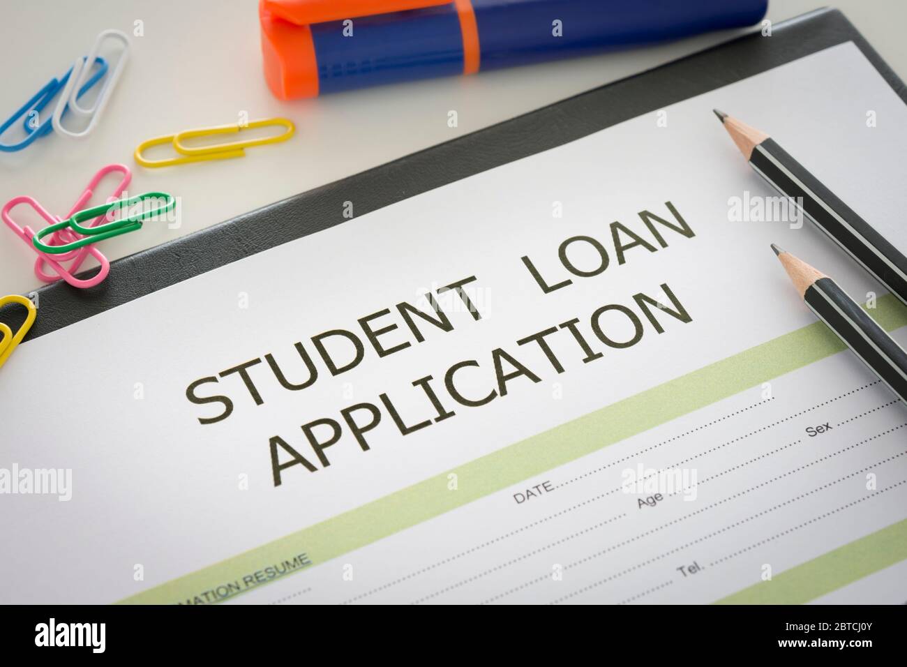 Student loan application form on desk with stationery Stock Photo - Alamy