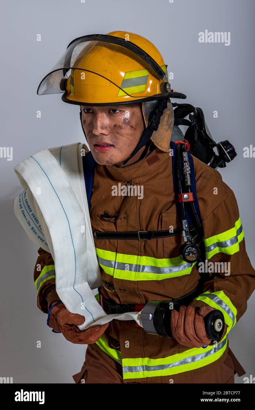 Asian male and female firefighter portrait, young smiling fireman in ...