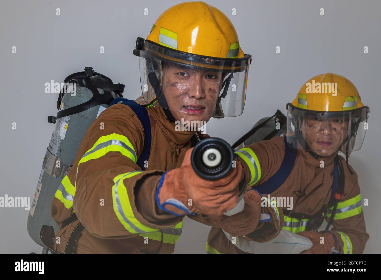 Asian male and female firefighter portrait, young smiling fireman in ...