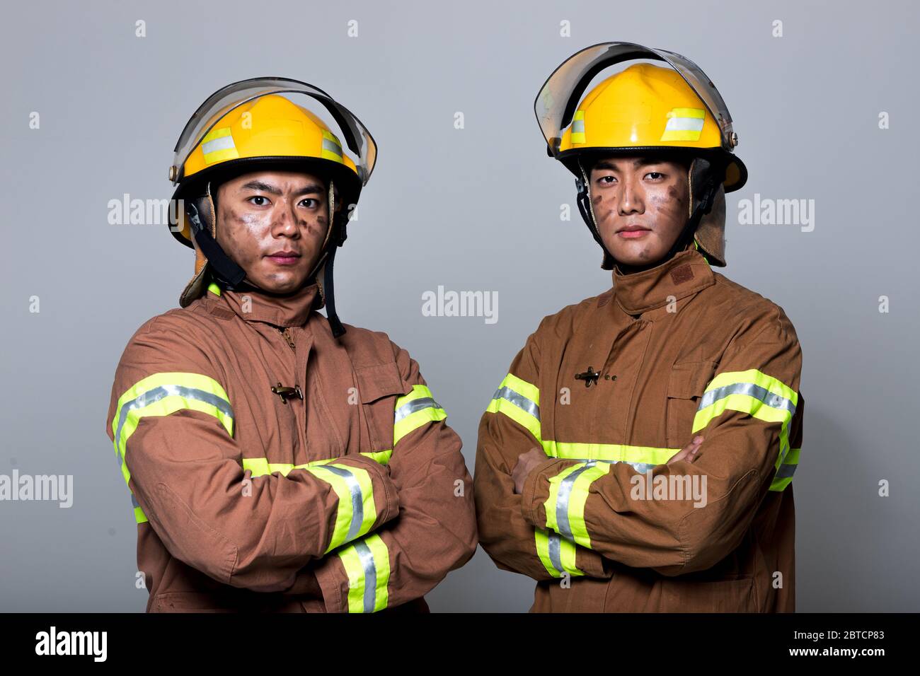Asian male and female firefighter portrait, young smiling fireman in ...