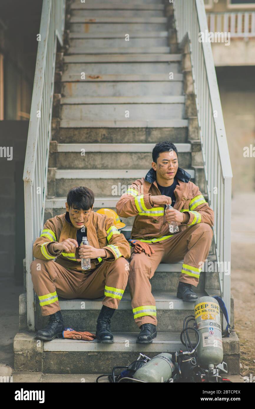 Asian male and female firefighter portrait, young smiling fireman in ...