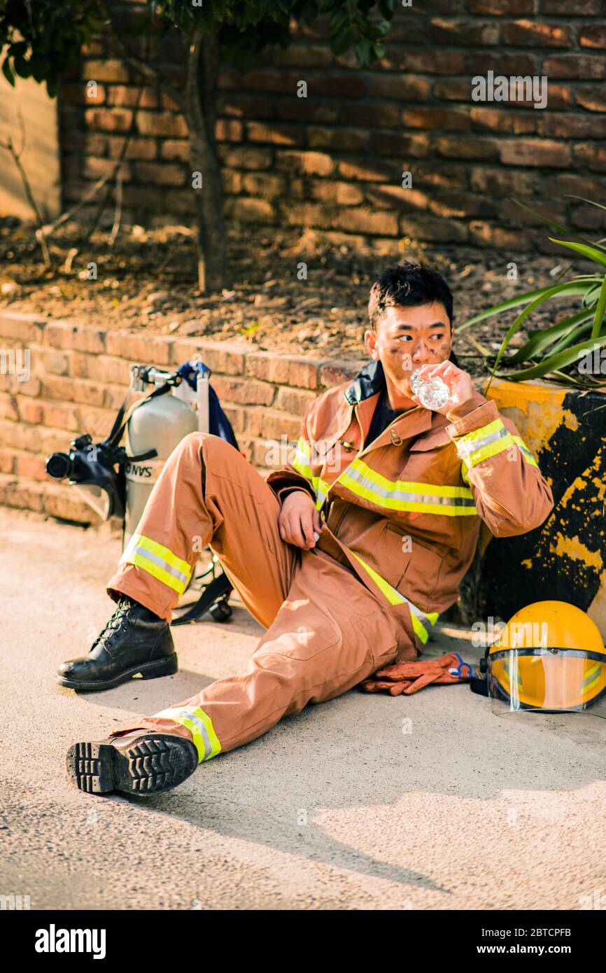 Asian male and female firefighter portrait, young smiling fireman in ...