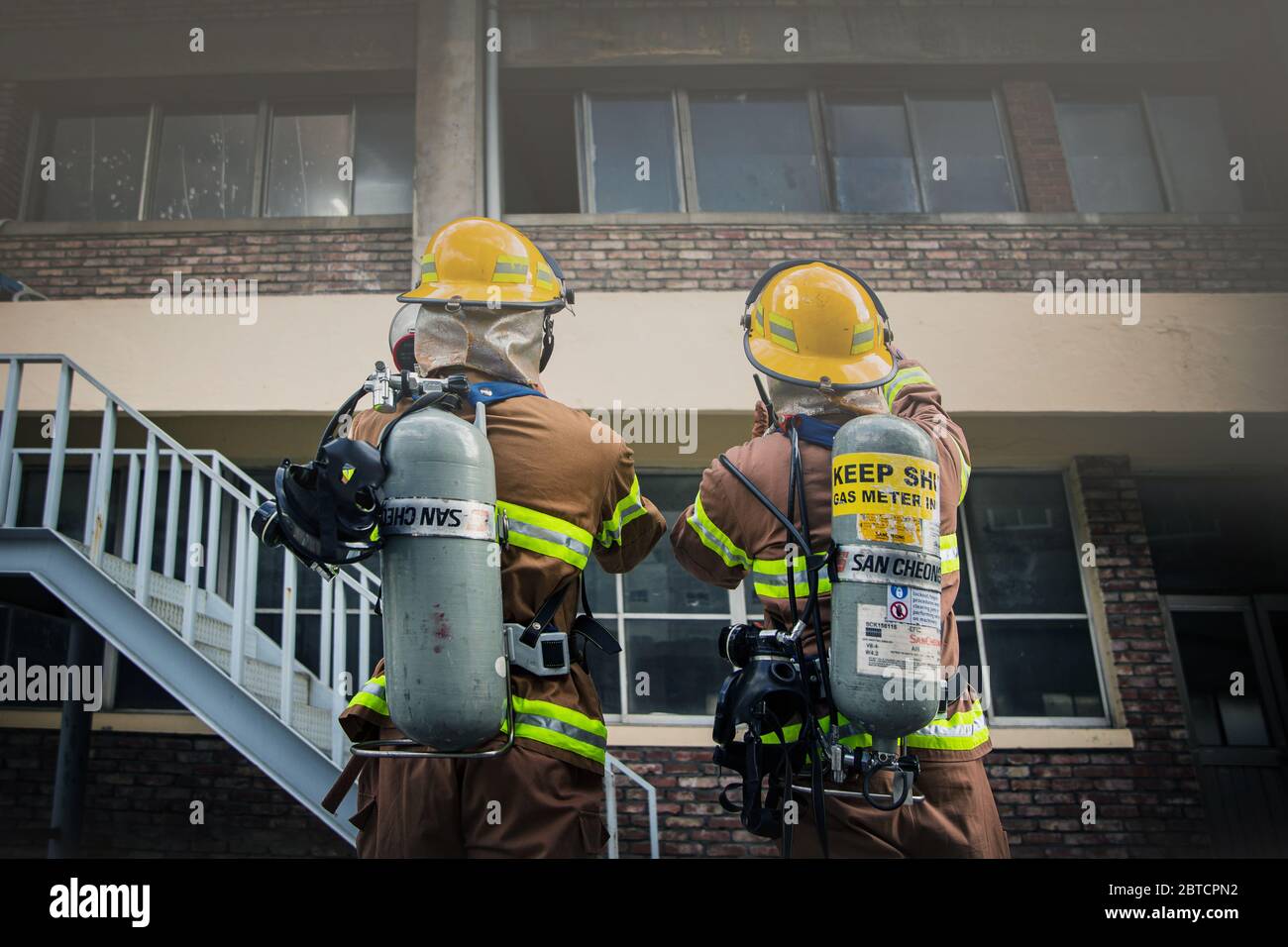 Asian male and female firefighter portrait, young smiling fireman in ...