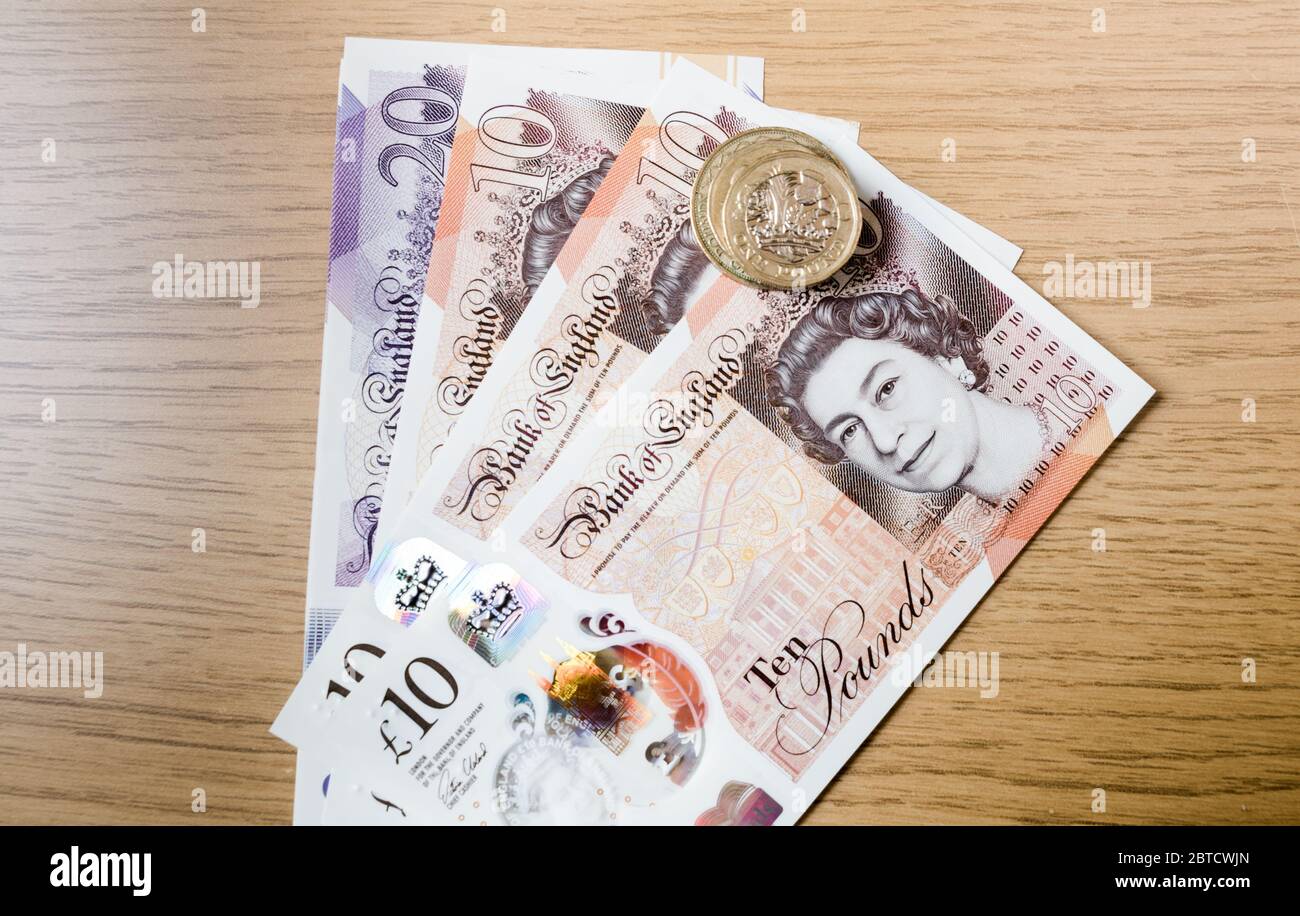 British pound currency polymer notes and coins Stock Photo - Alamy