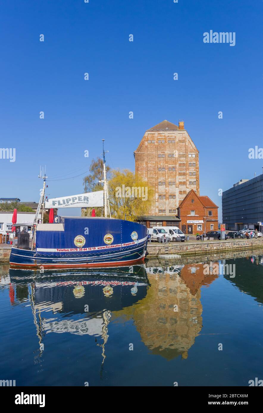 Old boat and warehouse in the harbor of Stralsund, Germany Stock Photo ...