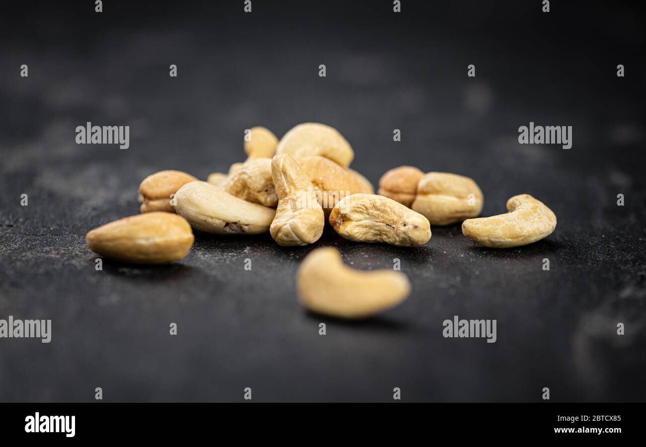Some roasted Cashew Nuts as detailed close up shot (selective focus ...