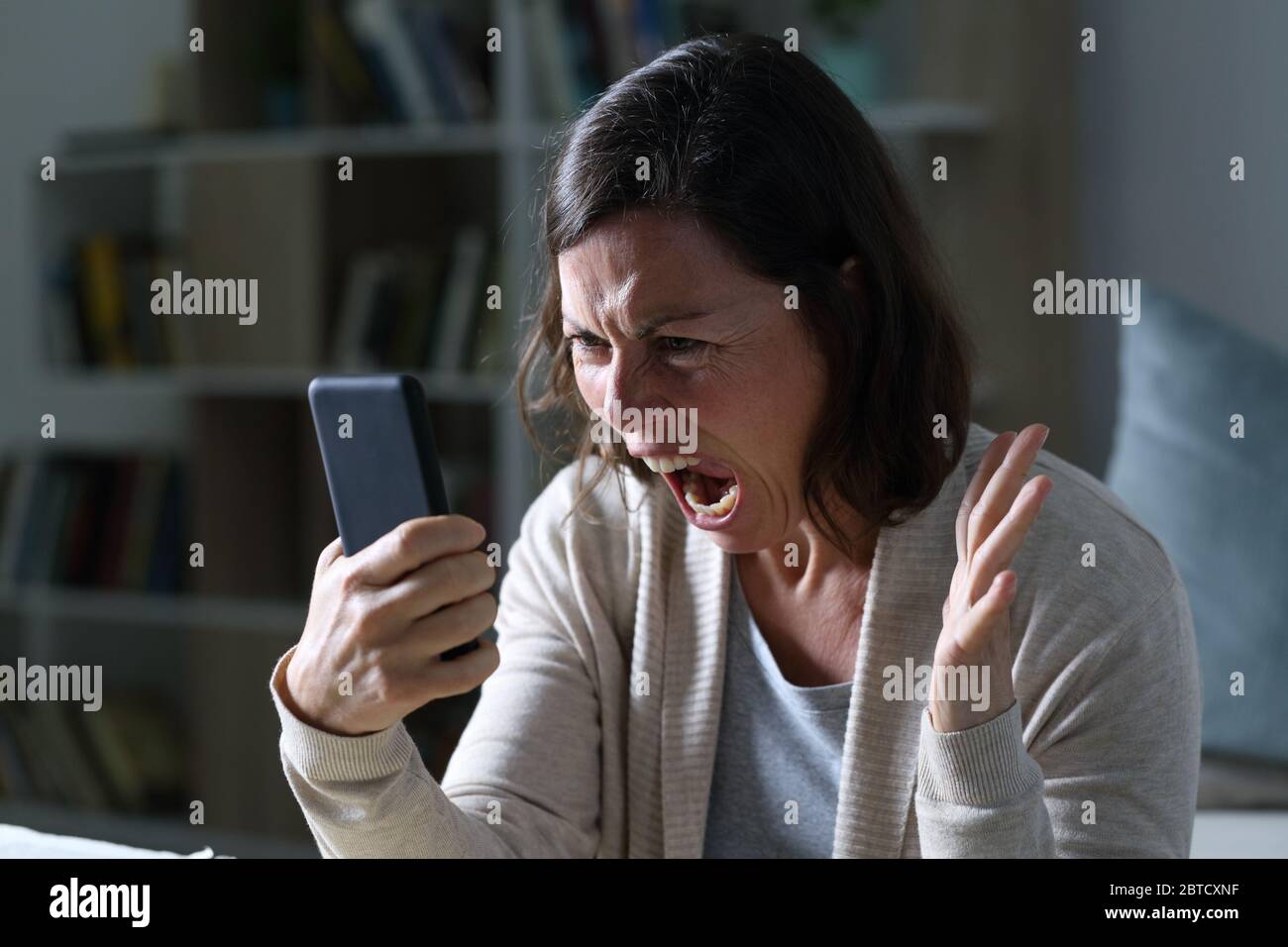 Angry woman shouting night home hi-res stock photography and images - Alamy