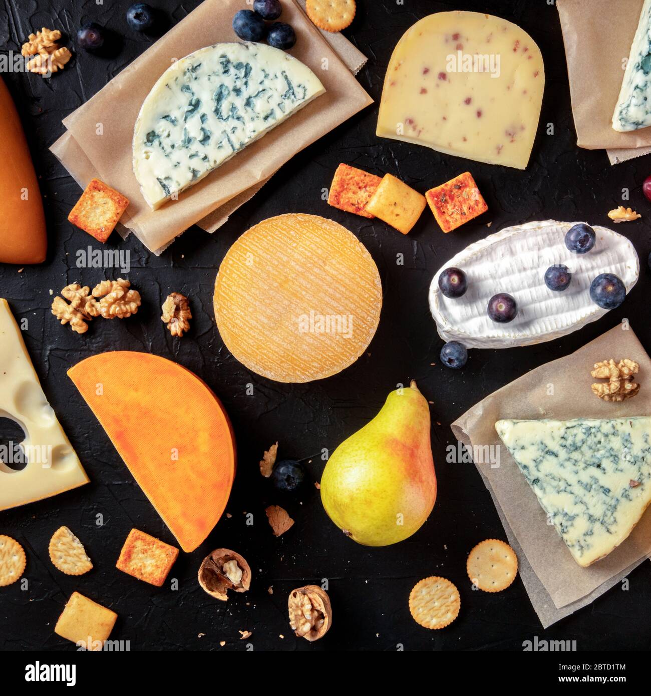 Cheese flat lay. An assortment of many different cheeses, overhead ...