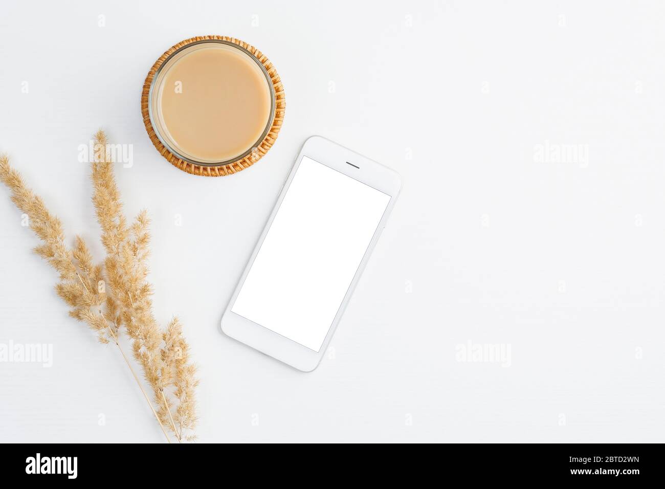 Flat lay mobile phone mockup with empty screen, dry reed decor and cup ...