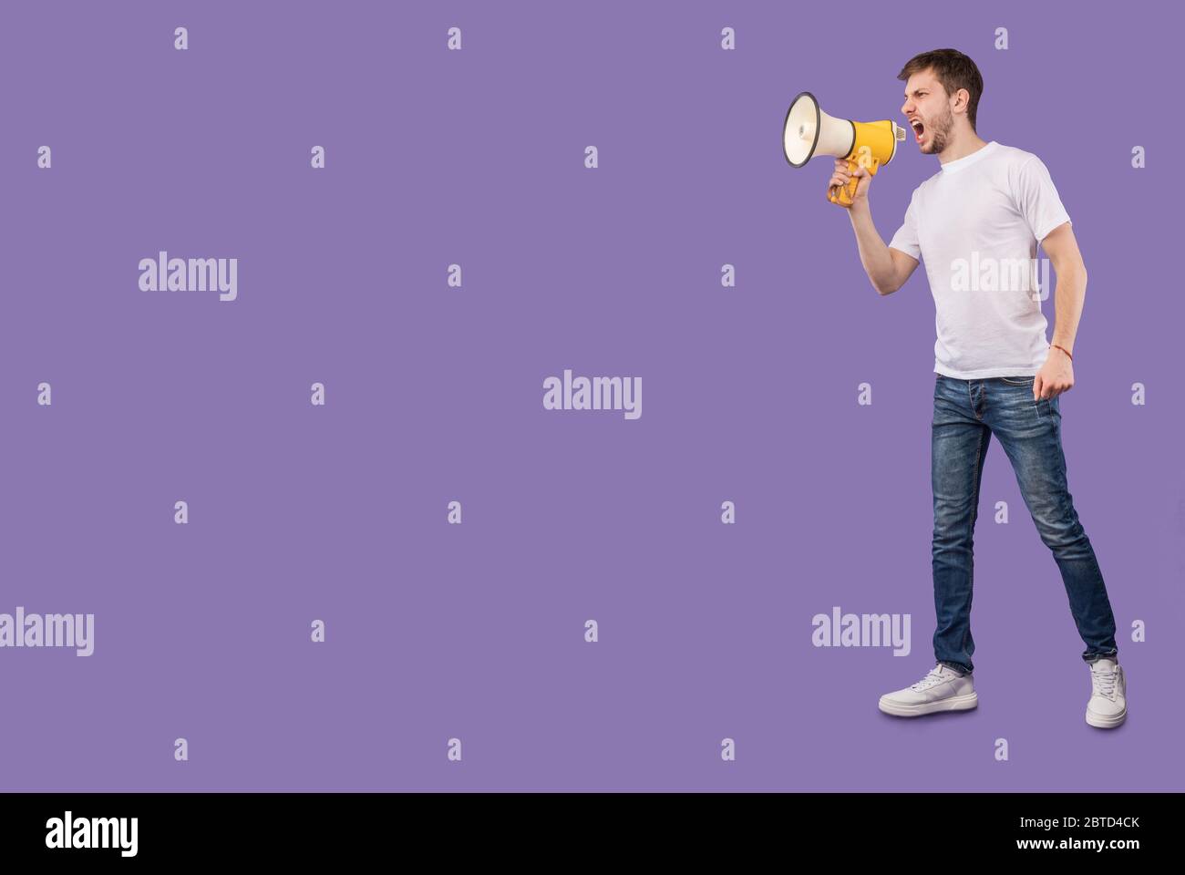 Aggressive man shouting with megaphone, isolated on purple Stock Photo ...