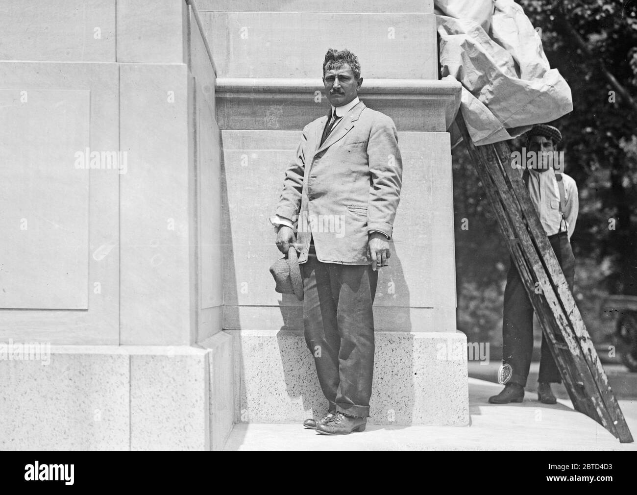 Sculptor Attilio Piccirilli standing next to the memorial he designed ...