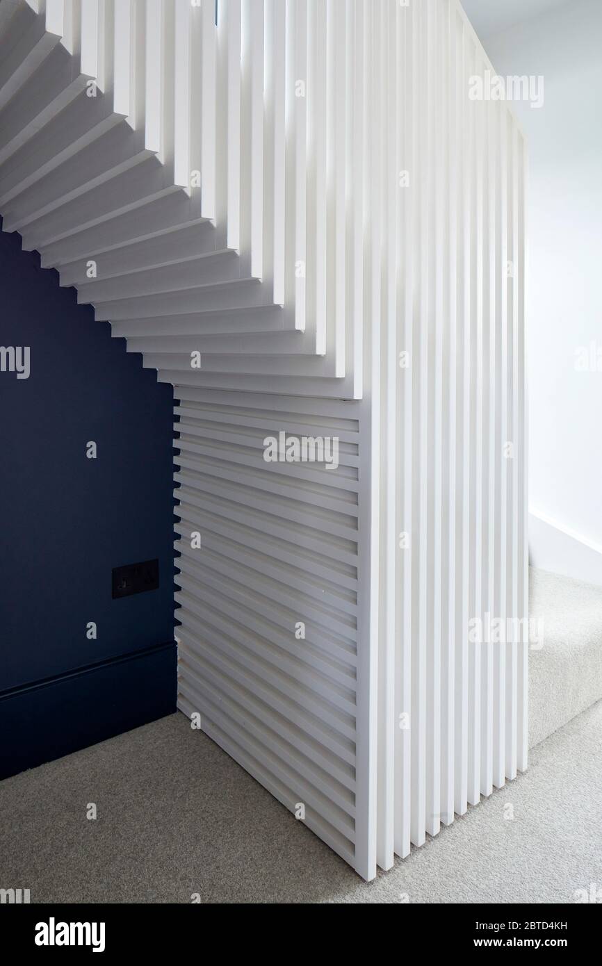 White staircase with ribbed wooden slat design. Long House, London ...