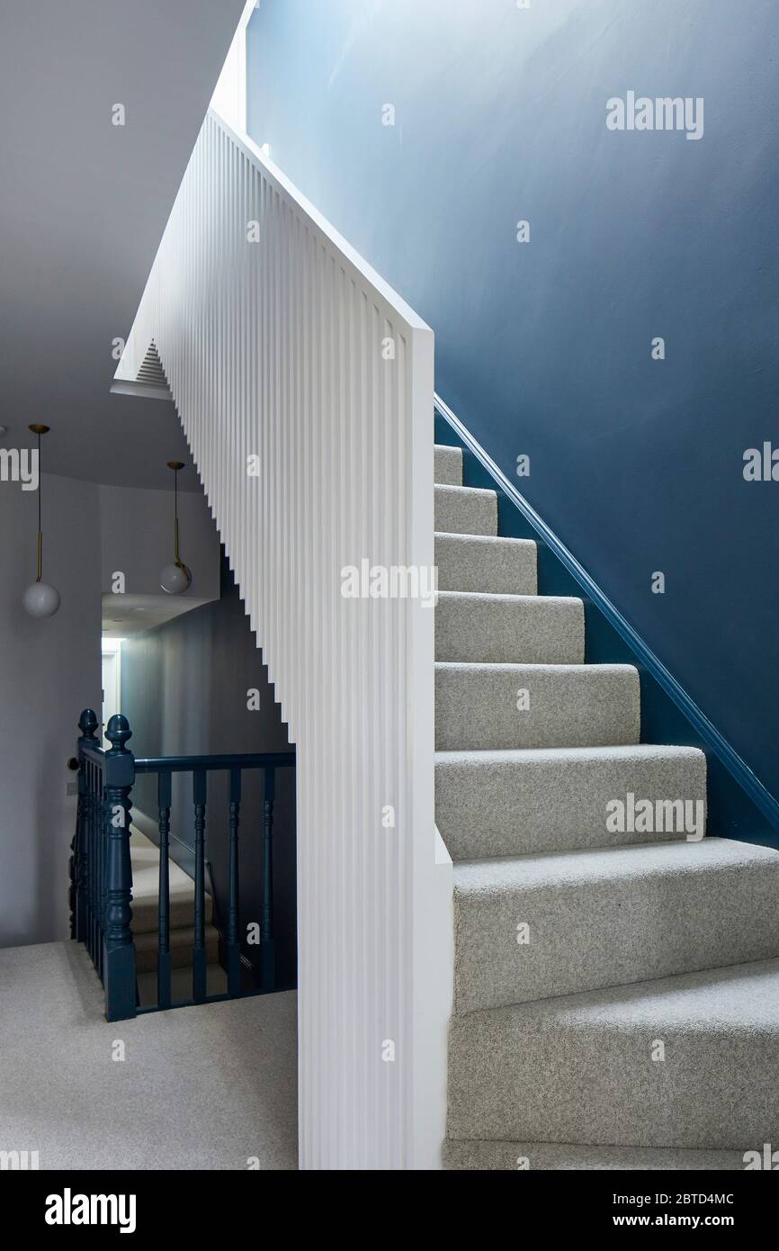 White staircase with ribbed wooden slat design. Long House, London ...