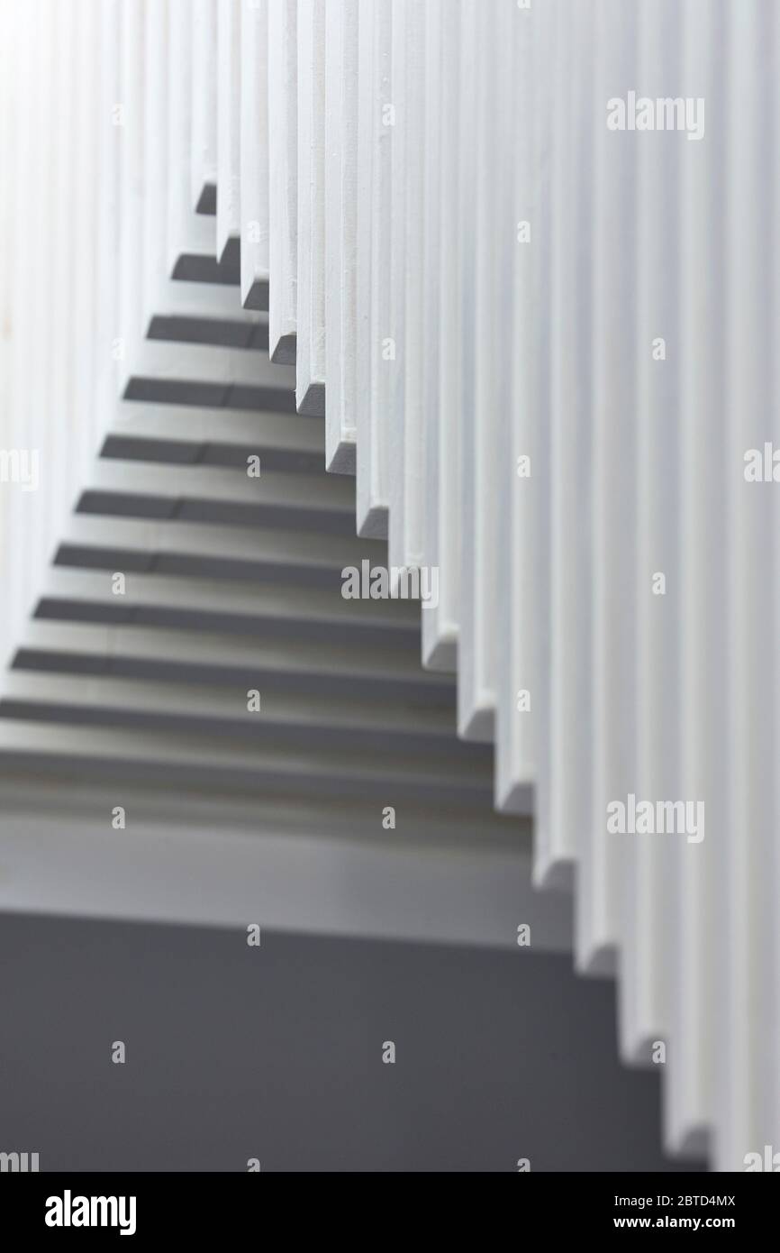Abstract detail White staircase with ribbed wooden slat design. Long ...