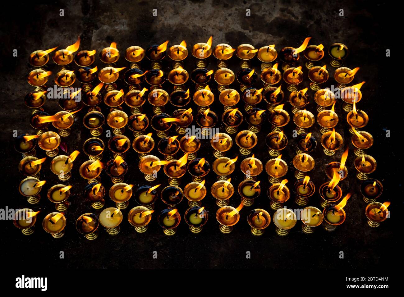 Oil butter lamps burning in hindu temple hi-res stock photography and ...