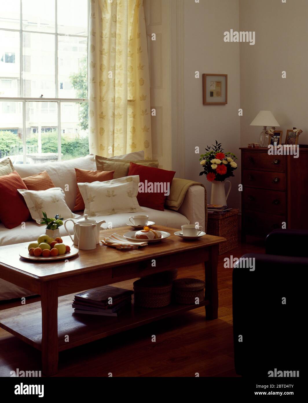 Coffee table set for tea in living room with cream sofa Stock Photo - Alamy