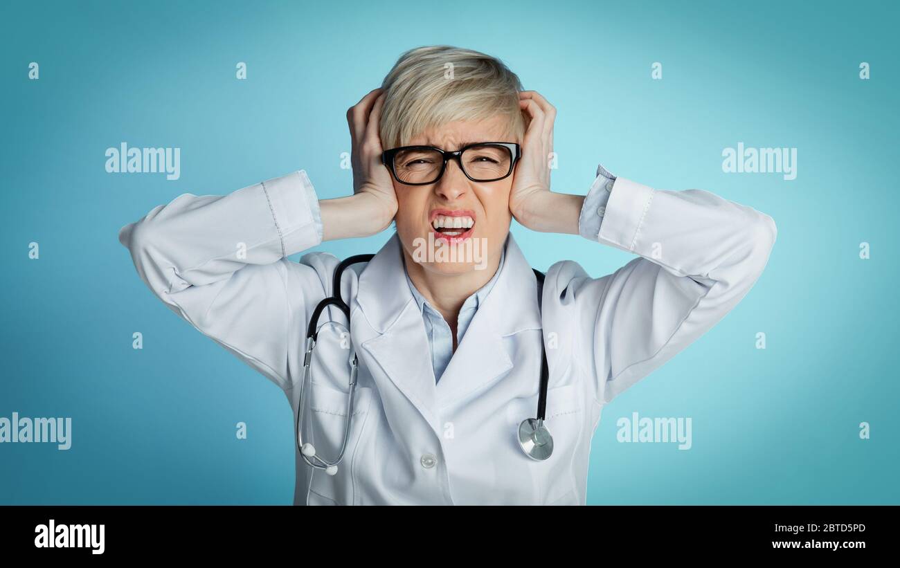 Headache from problems in medicine. Upset doctor holds her head with ...