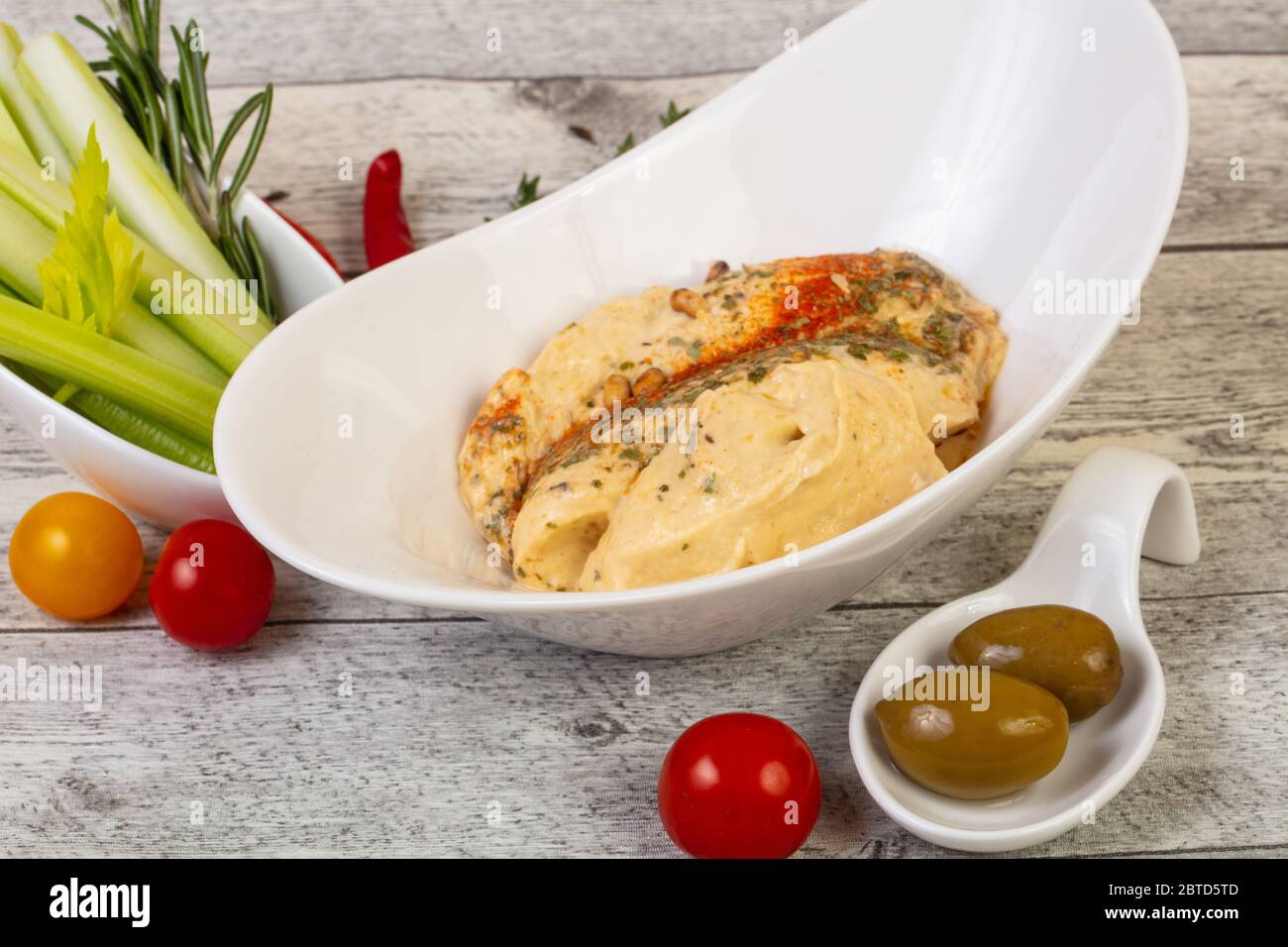 Vegan cuisine - Humus with celery sticks Stock Photo - Alamy