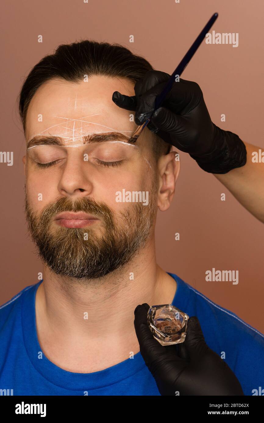 Studio makeup process hands with brush hi-res stock photography and ...