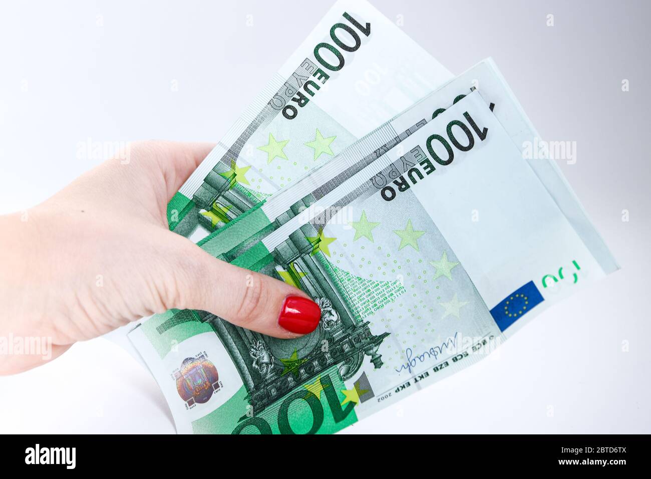Euro bills in female hands. Euro cash background on white, fan of 100 ...
