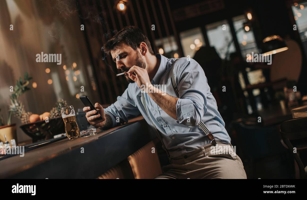 Handsome guy smoking cigar bar hi-res stock photography and images - Alamy