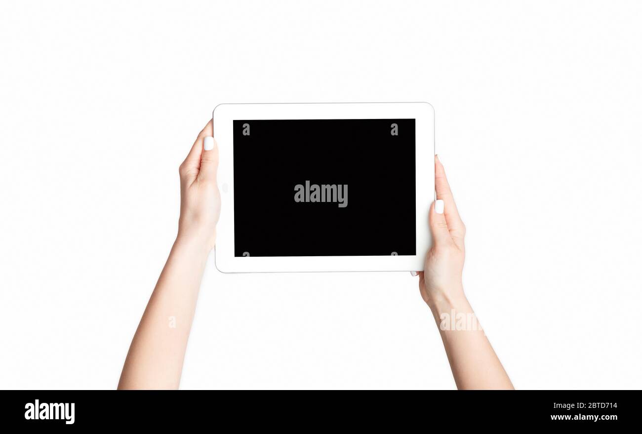 View of girl hands holding tablet computer with mockup for design on ...