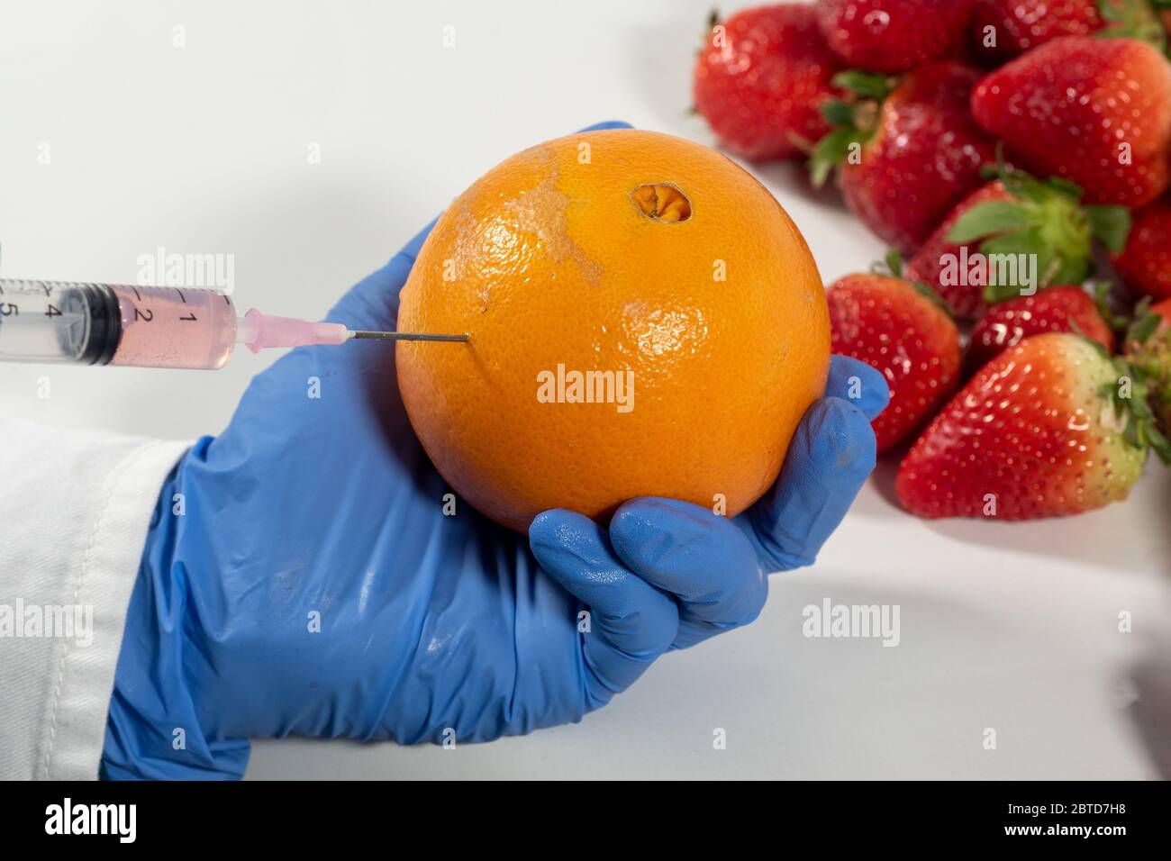Syringe injecting orange fruit hi-res stock photography and images - Alamy