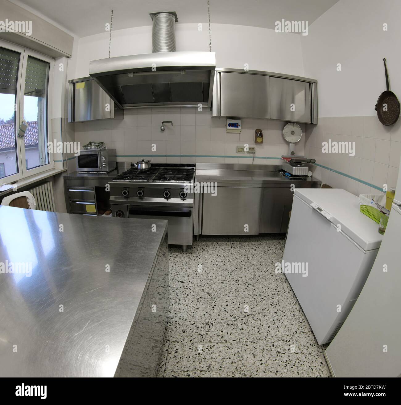 large interior of industrial kitchen with stainless steel stove and ...