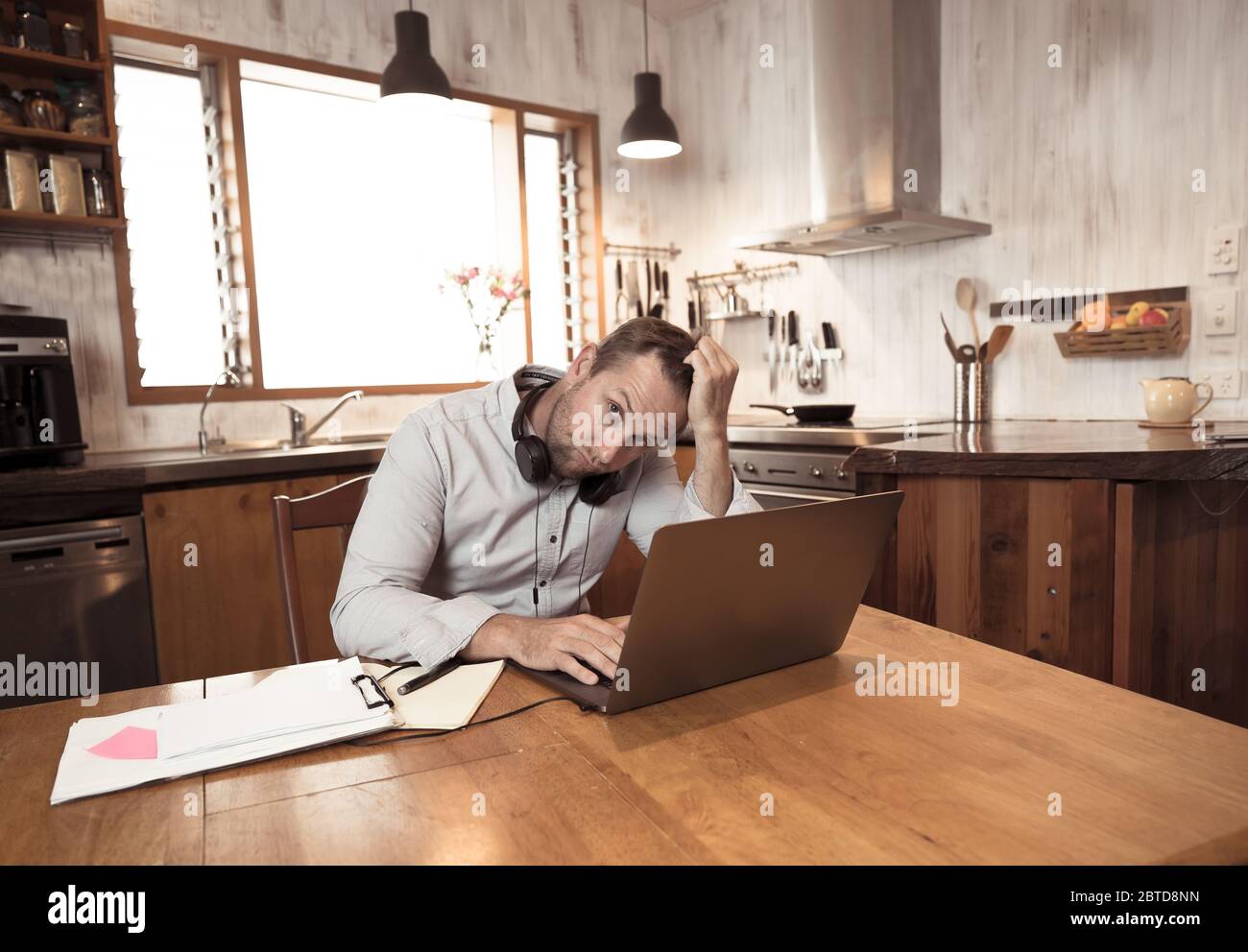 Stressed business man on laptop working from home looking worried ...