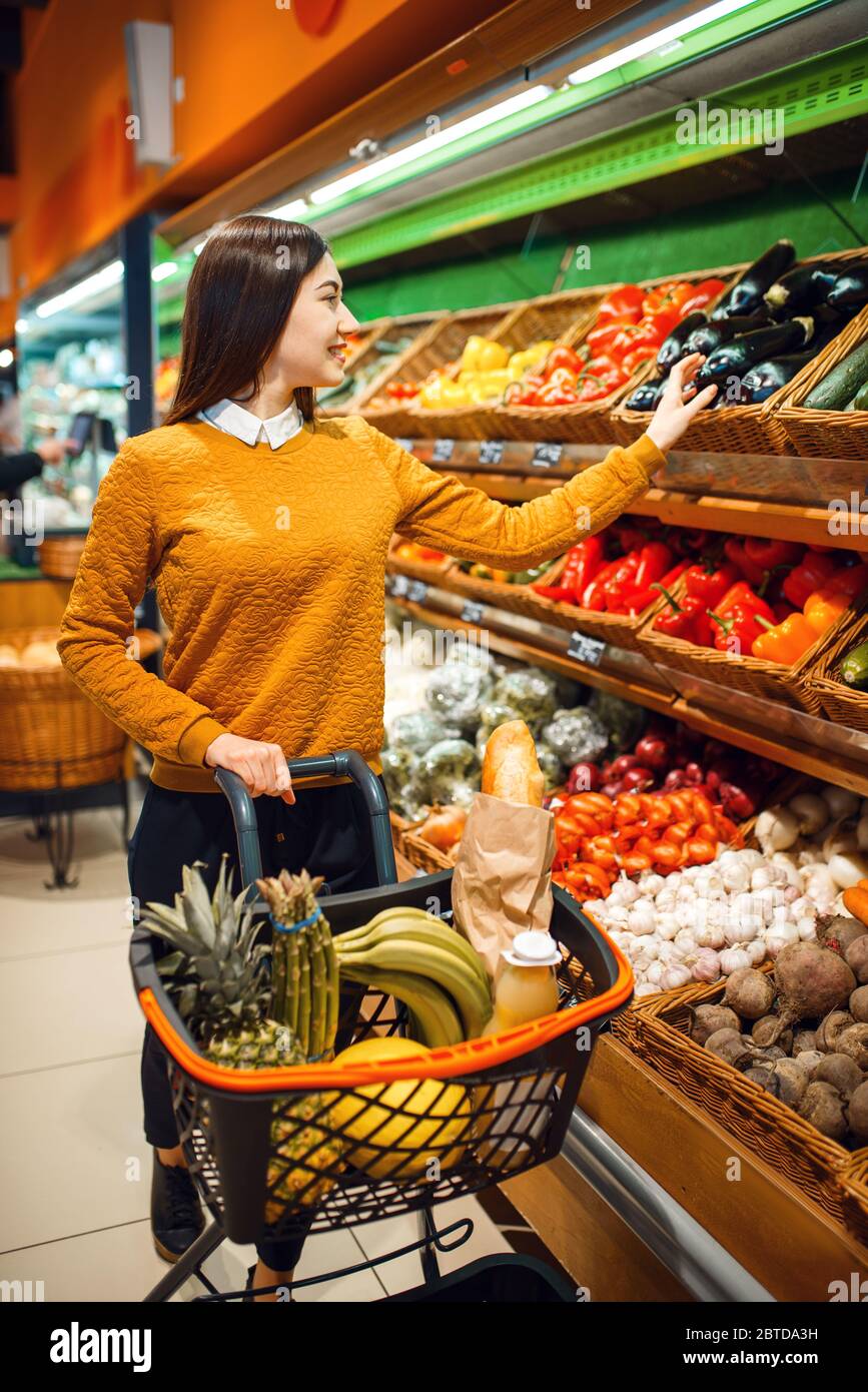 Beautiful young woman shopping basket hi-res stock photography and ...