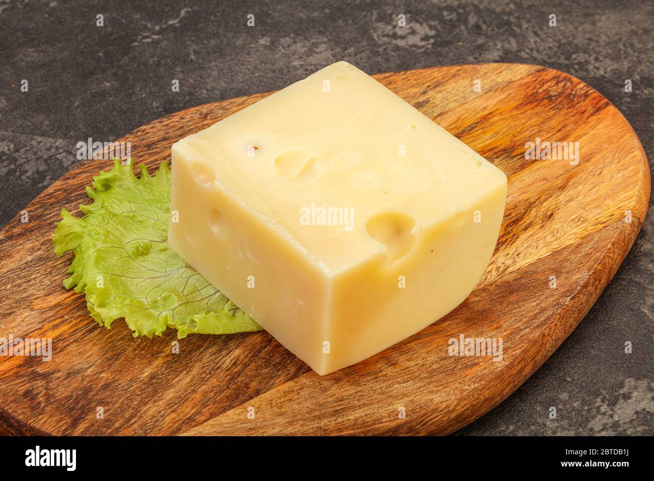 Emmental cheese over wooden board served salad Stock Photo - Alamy