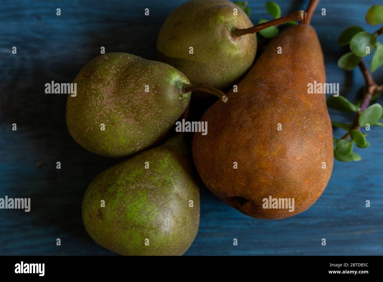Whole pears on blue board, ready to eat Stock Photo - Alamy
