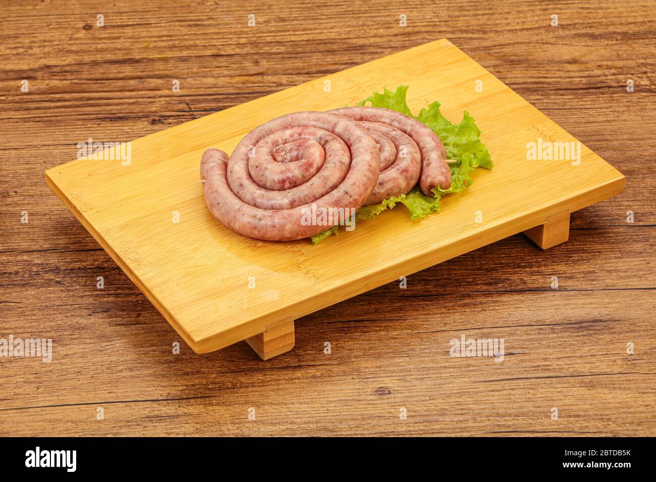 Raw pork sausage ring for grill Stock Photo - Alamy