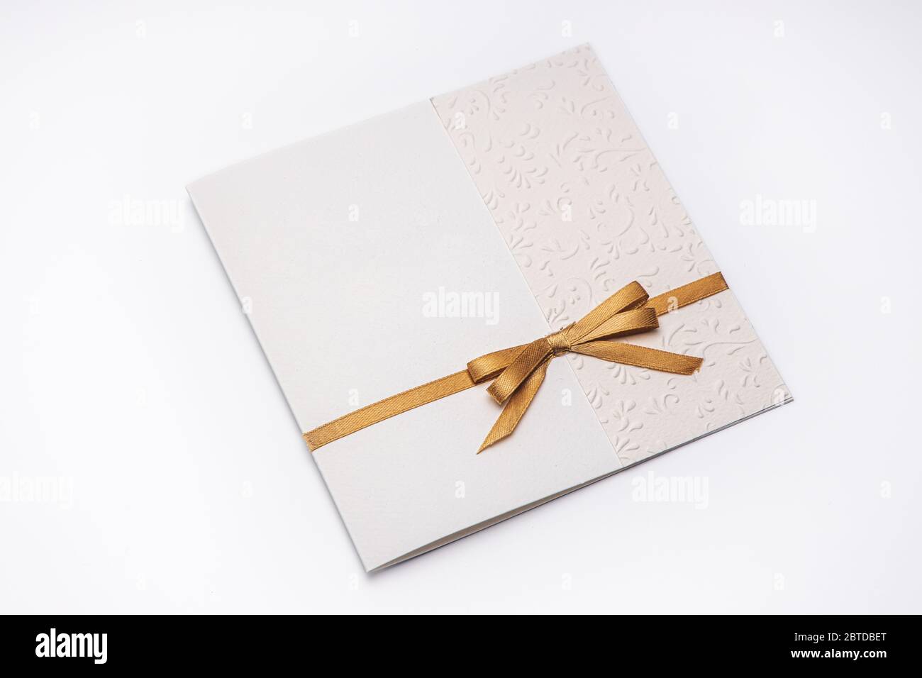 Greeting card with gold ribbon isolated on white background Stock Photo ...